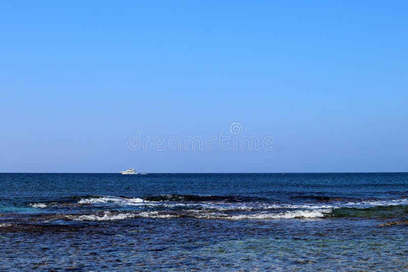 White Boat Sailing on Horizon in the Calm Bright Blue Sea Stock Image ...