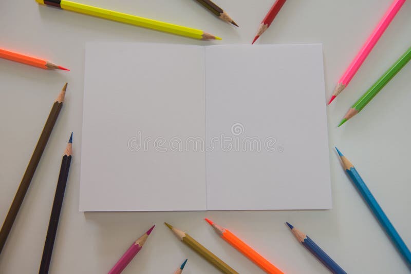 White Book and Colorful Many Crayons on the Table Stock Image - Image ...
