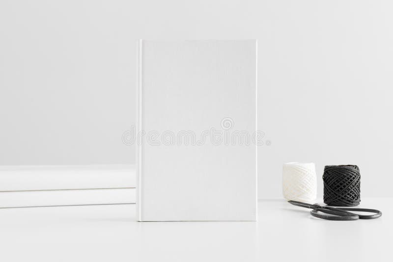 White Book Mockup with Workspace Accessories on a White Table Stock ...