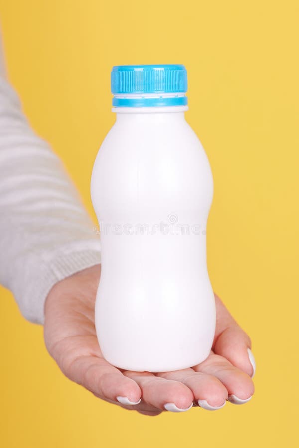 White Bottle with Kids Yogurt in Hand, Isolated on Yellow Background ...