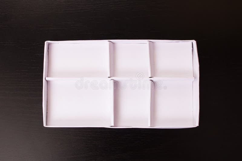 White Box with Cells on Wooden Table Stock Image - Image of table ...