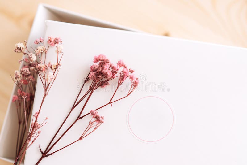 White Box with Flowers without Inscriptions on a Wooden Table Stock ... White Box with Flowers without Inscriptions on a Wooden Table Stock ...