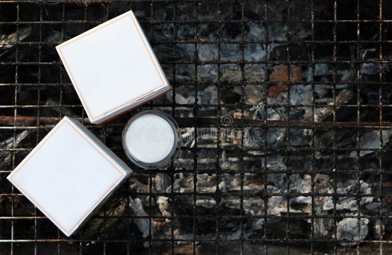 White Boxes and Jars for Products Put on Steel Grid. Stock Photo ...