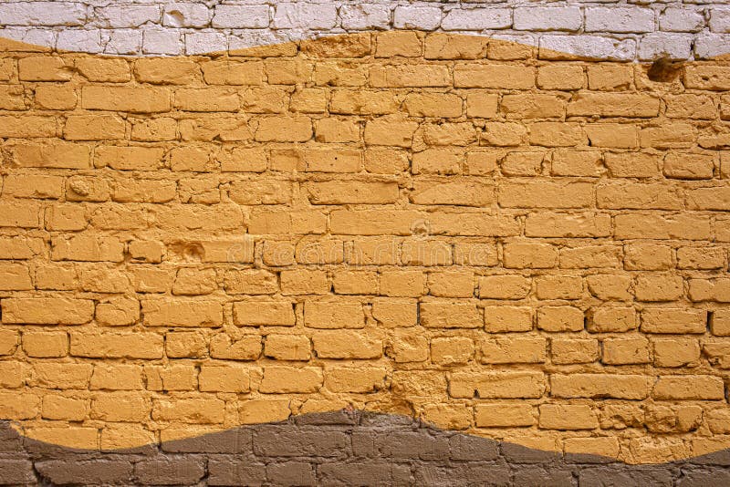 A White Brick Wall is Adorned with a Wide Yellow Wave of Paint. Stock ...