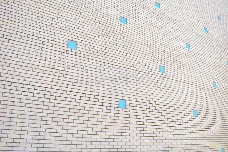 White Brick Wall with Diagonal Pattern of Square Blue Tiles Stock Image ...