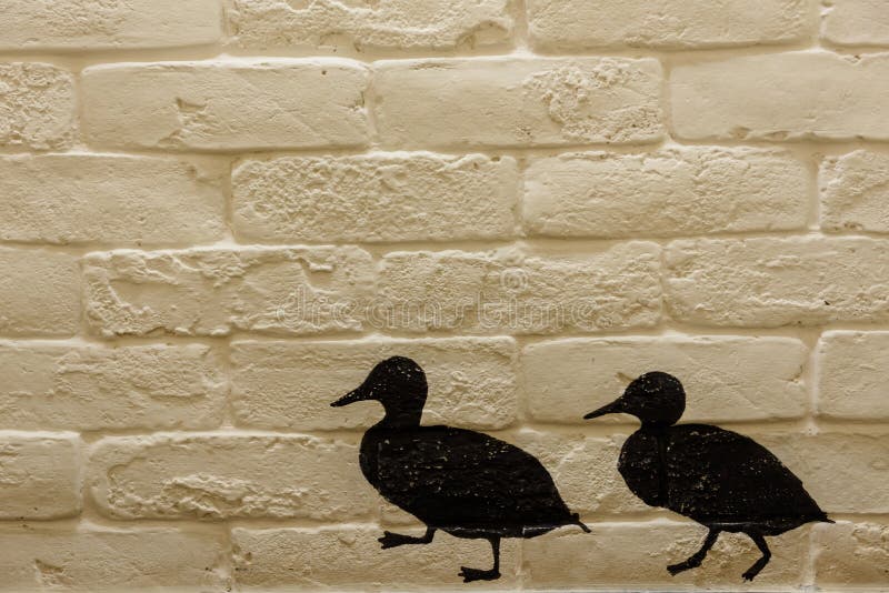 Brick Wall with Silhouette Walking Ducks Stock Image - Image of duck ...
