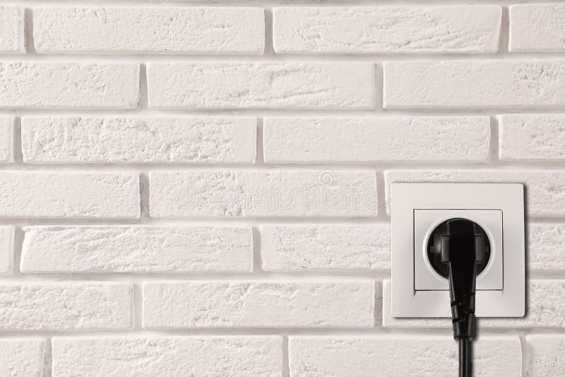 Brick Wall with Power Socket and Inserted Plug, Space for Text ...