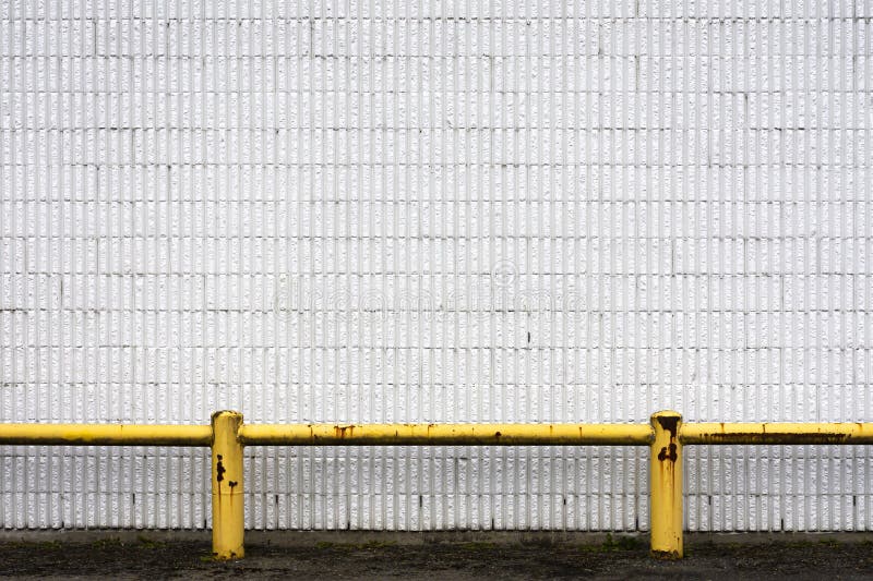 White Brick Wall and Yellow Guard Rails Stock Photo - Image of ...