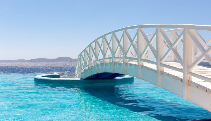 White Bridge Over Infinity Pool Stock Image - Image of resort ...