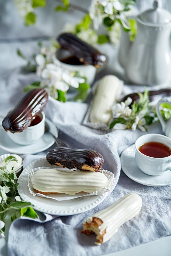 Eclairs with tea stock image. Image of dessert, petals - 142534957