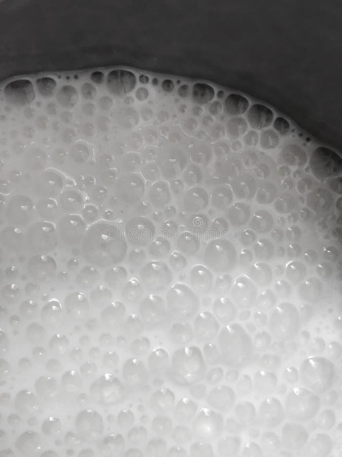 Boiling milk in a pan. stock image. Image of droplet - 189818529