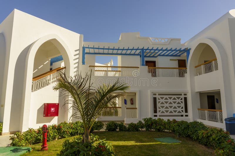 A White Building with Blue Accents and a Red Box on the Front Stock ...