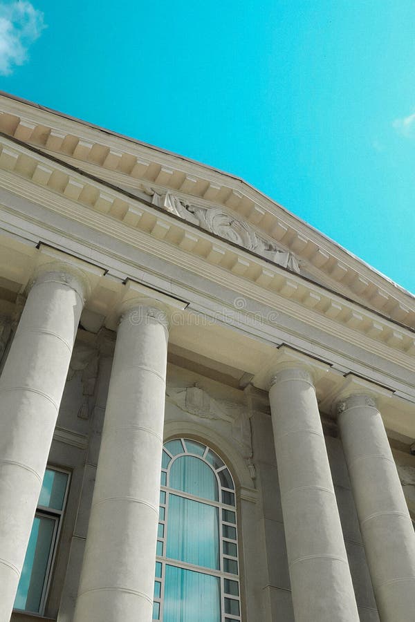 A White Building with Columns and Beautiful Architecture Against a ...