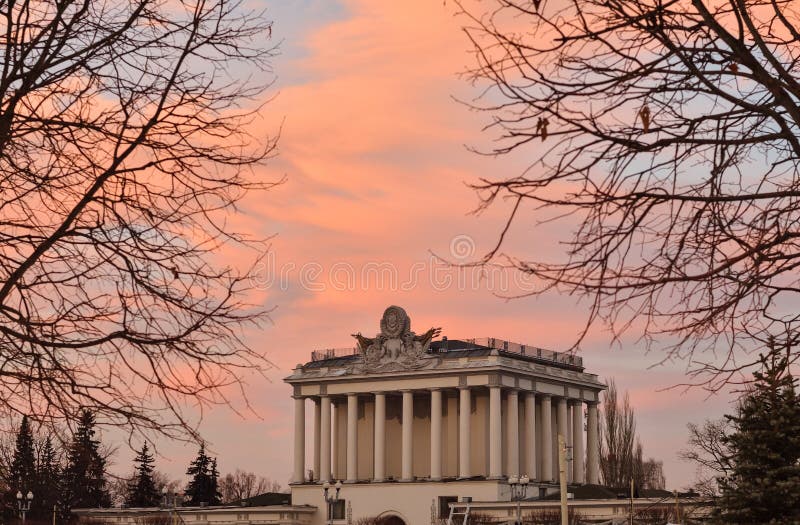 White Building with Columns between Tree Branches Against Stock Photo ...