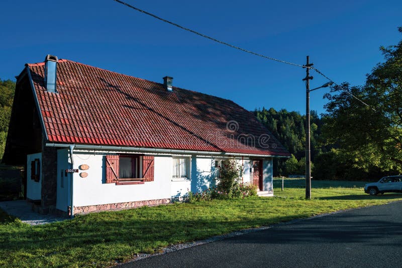 White Building with a Red Roof Surrounded by Green Trees. Editorial ...