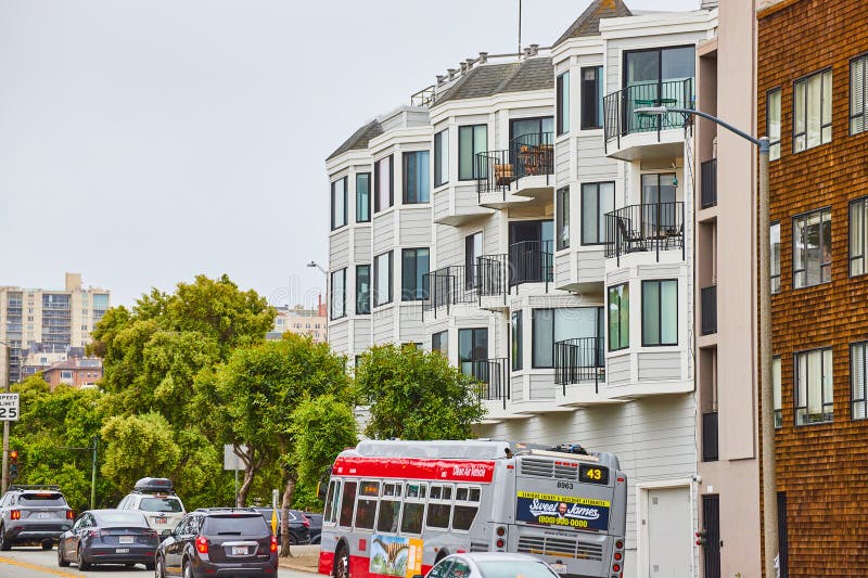 White Building Side View of Front Bay Windows with Black Balconies and ...