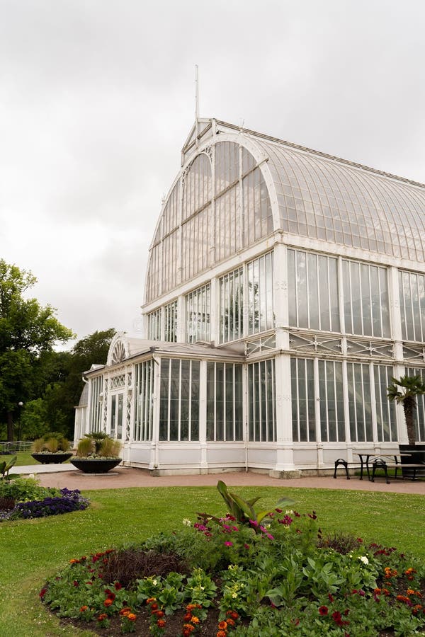 A White Building that is in the Middle of Some Grass Editorial Stock ...