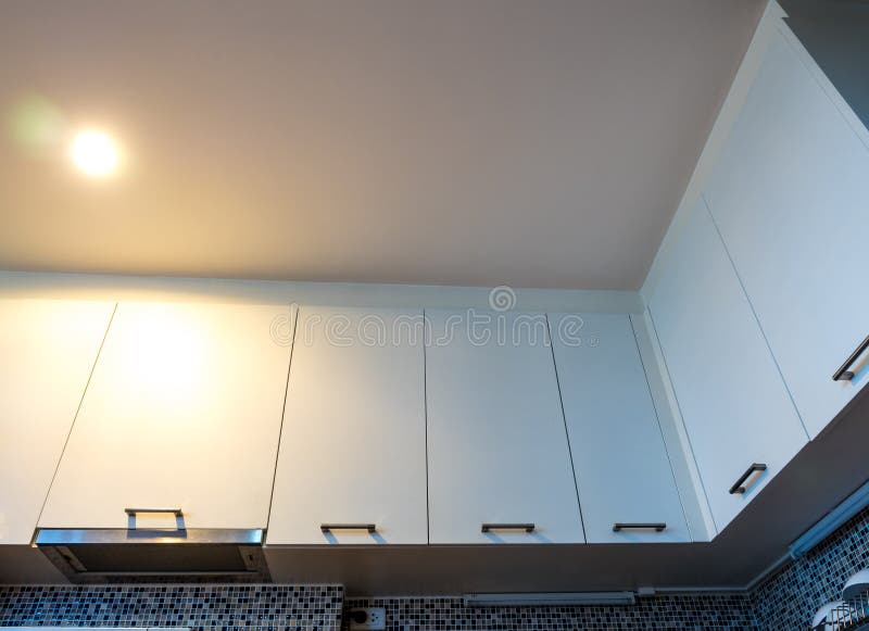 White Built-in Storage Cabinet Above the Kitchen Counter Stock Image ...