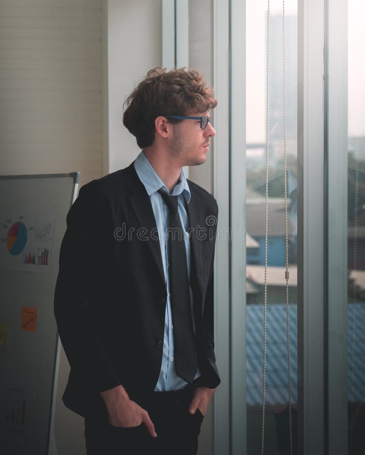 White Businessman Looking Out Windows with Hopeful Face Standing Stock ...