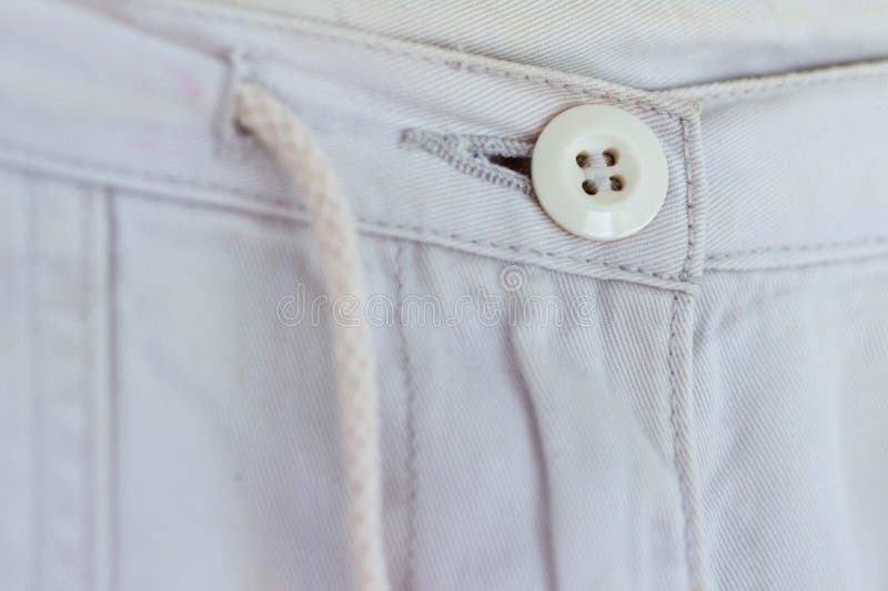 White Button and Drawstring Detail on Light-colored Cotton Pants Stock ...