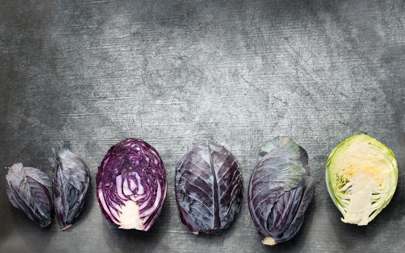 White Cabbage and Red Cabbage Lying Next To Each Other on a Gray ...