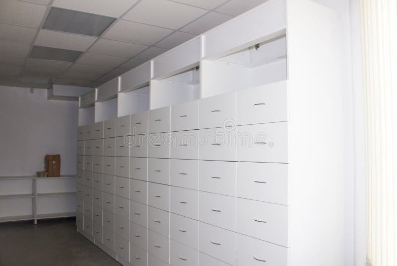 White Cabinets in a Pharmacy or Medical Laboratory. Light Walls and ...