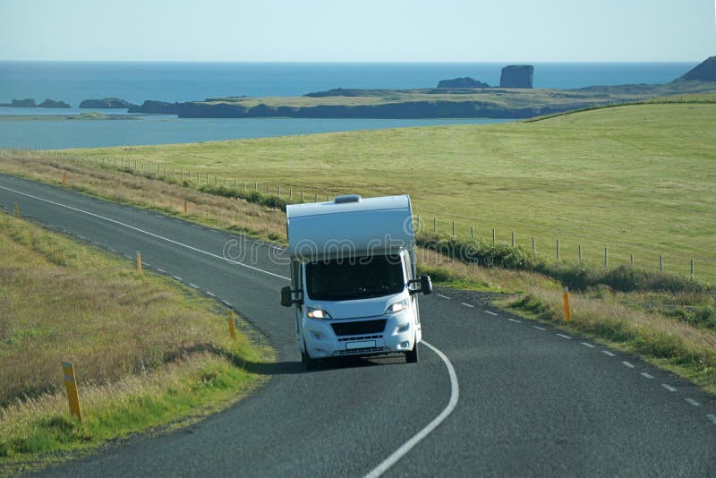 White Camper Driving on a Road - Front View Stock Photo - Image of ...