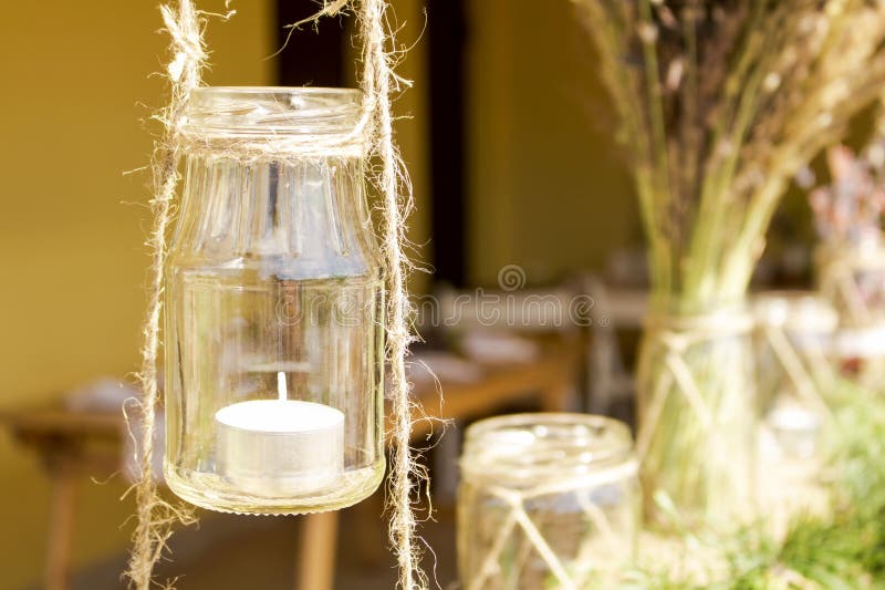 White Candle Inside a Glass Jar, Decorated with String on the ...