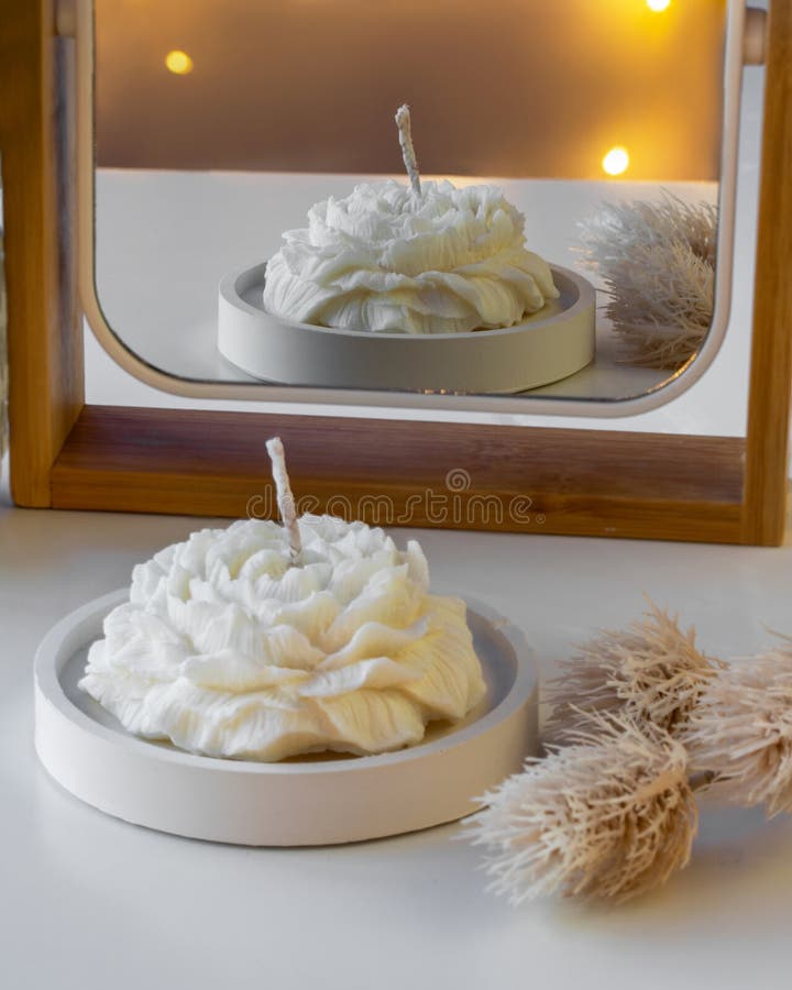 White Candle in the Shape of a Flower on the Table Near the Mirror with ...