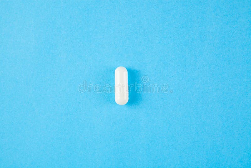 White Capsule on Blue Background Stock Photo - Image of background ...