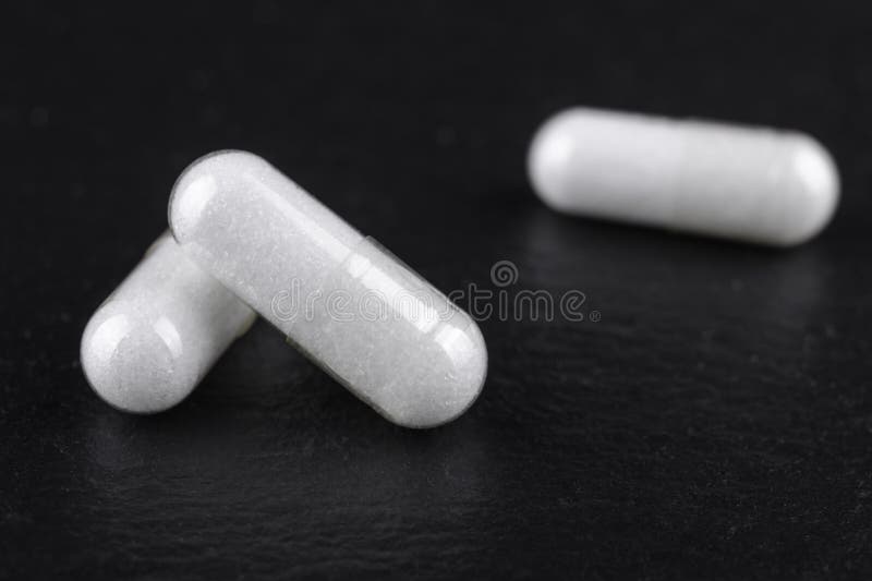 White Capsules of Nutritional Supplement Msm, Sulfur on Black ...