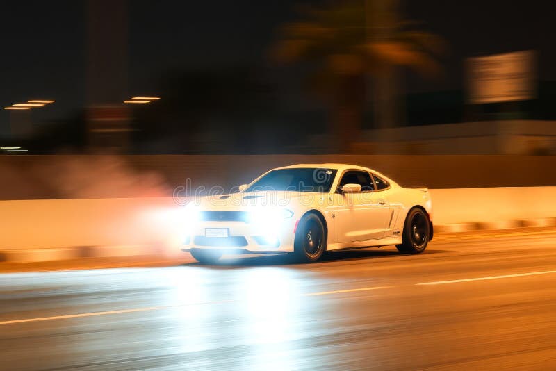 White Car is Driving Down a Street at Night Stock Image - Image of ...