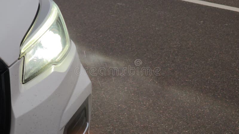 White Car LED Headlight Rays Shine through the Raindrops Stock Video ...