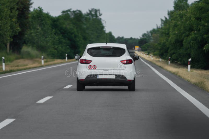 A White Car Overtakes a Red Car on an Open Road Stock Photo - Image of ...