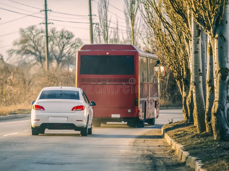 White Car and Red Bus on the Road Stock Photo - Image of fence, street ...