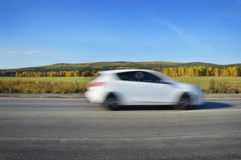 White Car Rides on the Road at High Speed Stock Image - Image of ...