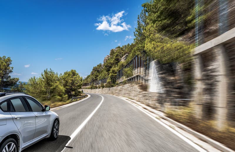 A White Car Rushing Along a High-speed Highway in the Sun. Stock Image ...
