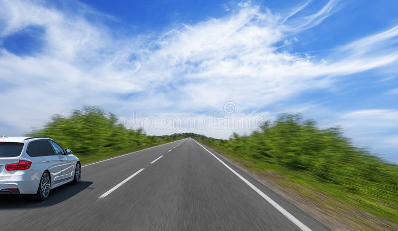 A White Car Speeds Down an Open Highway with Motion Blur on the ...