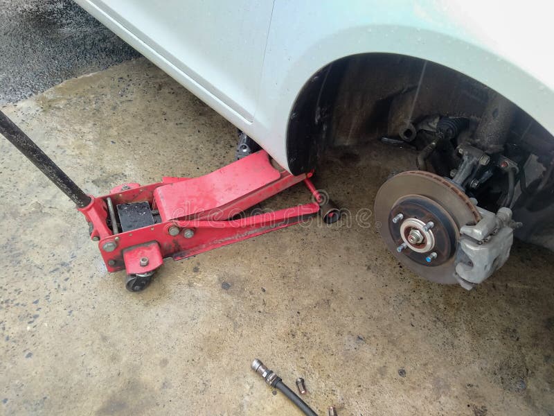 White Cars Change Wheels Using a Lifting Jack Stock Photo - Image of ...