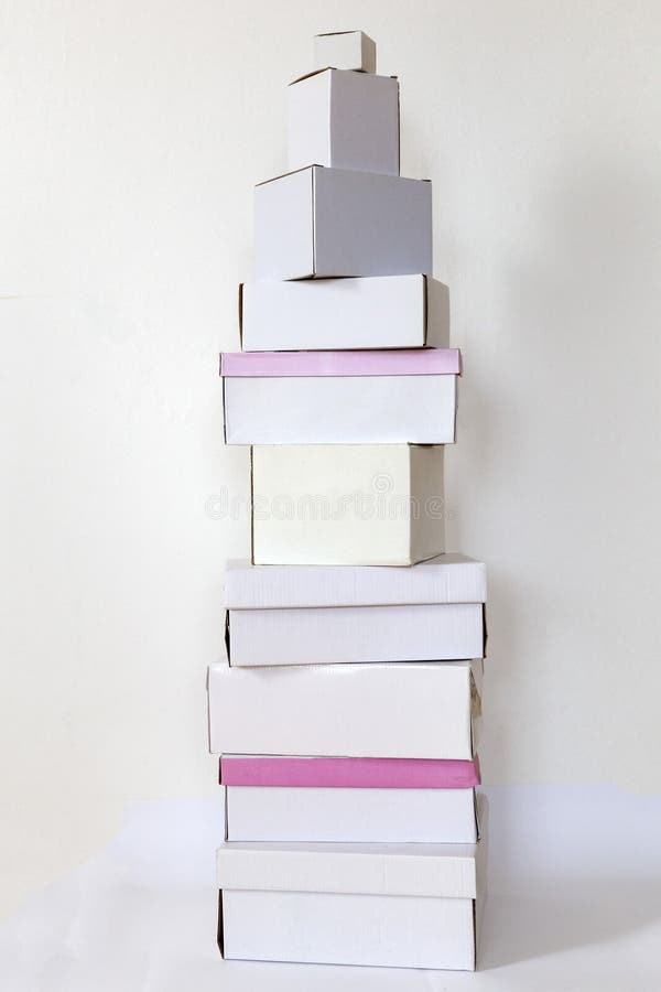 White Carton Boxes of Different Size Standing on Each Other As a High ...