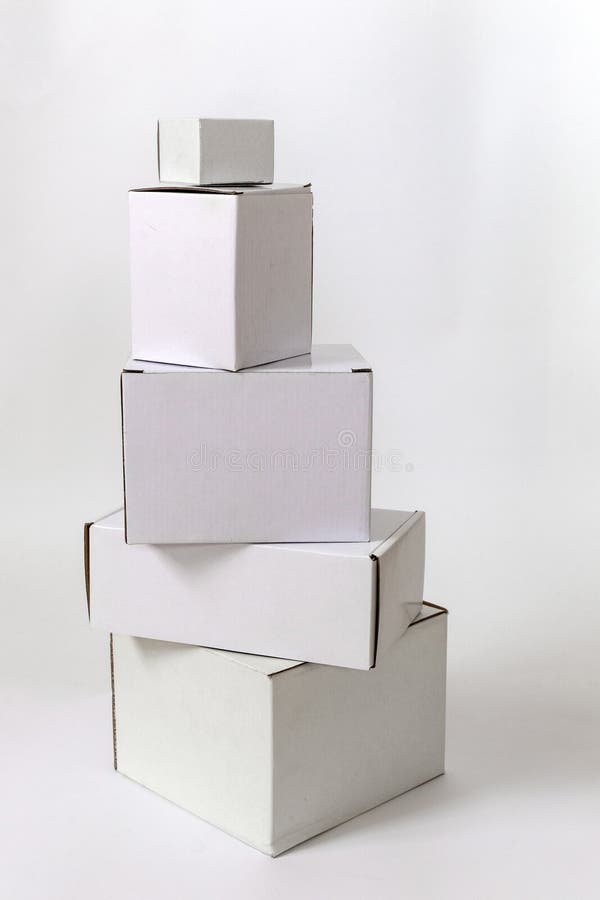 White Carton Boxes of Different Size Standing on Each Other As a High ...