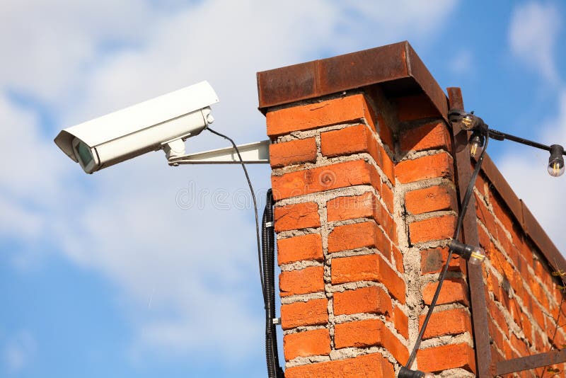White CCTV Camera is on High Point of Red Brick Wall Stock Photo ...