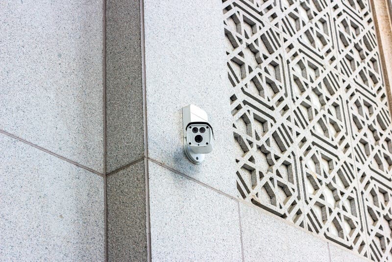 White CCTV Security Camera on the Wall on the City Street. Stock Image ...