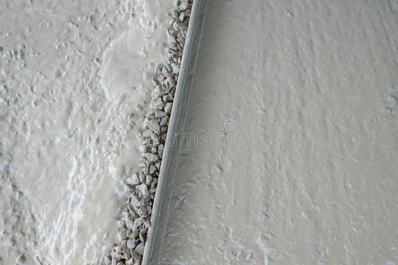 White Cement Slab with a White Line of Gravel on it Stock Photo - Image ...