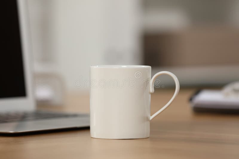 White Ceramic Mug and Laptop on Wooden Table at Workplace Stock Image ...