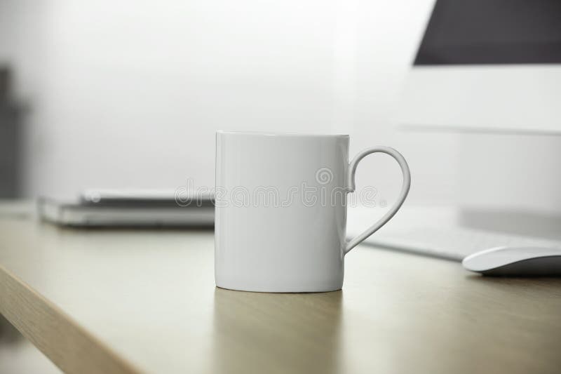White Ceramic Mug on Wooden Table at Workplace. Mockup for Design Stock ...