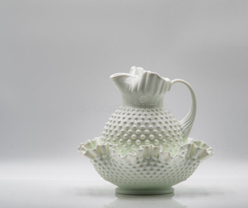 Beautiful White Ceramic Pitcher with Frilly Base Displayed Against a ...
