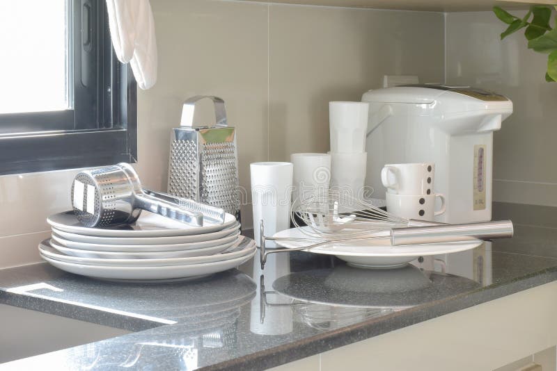 White Ceramic Set and Stainless Kitchen Utensils on the Counter Stock ...