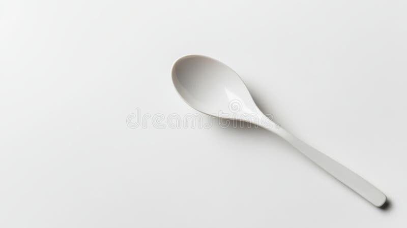 White Ceramic Spoon Lying on Pristine White Background, Showcasing ...