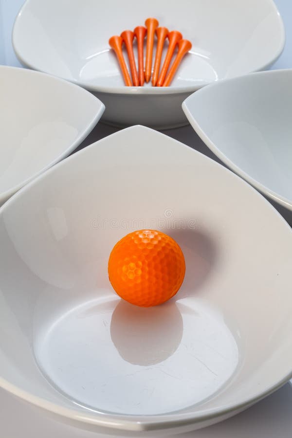 White Ceramics Bowls and Orange Golf Ball Stock Photo - Image of table ...